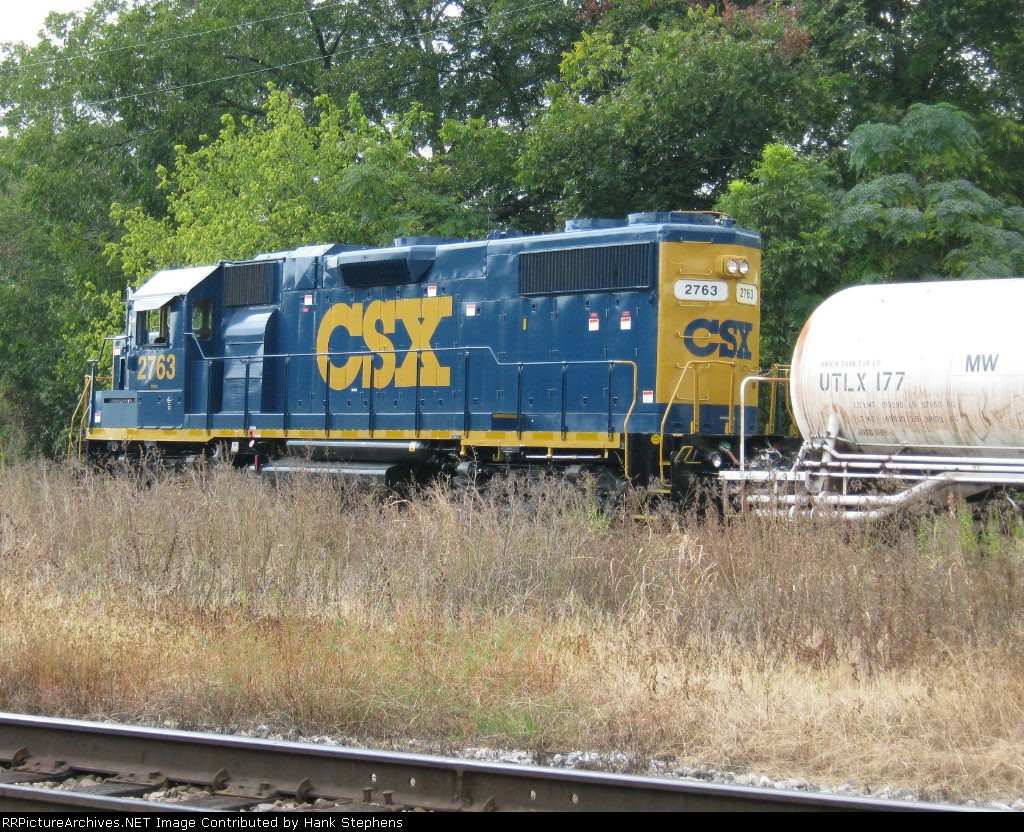 CSX Geep leads off Asplundh weed sprayer train as it sits in the transfer track with NS at Opelika